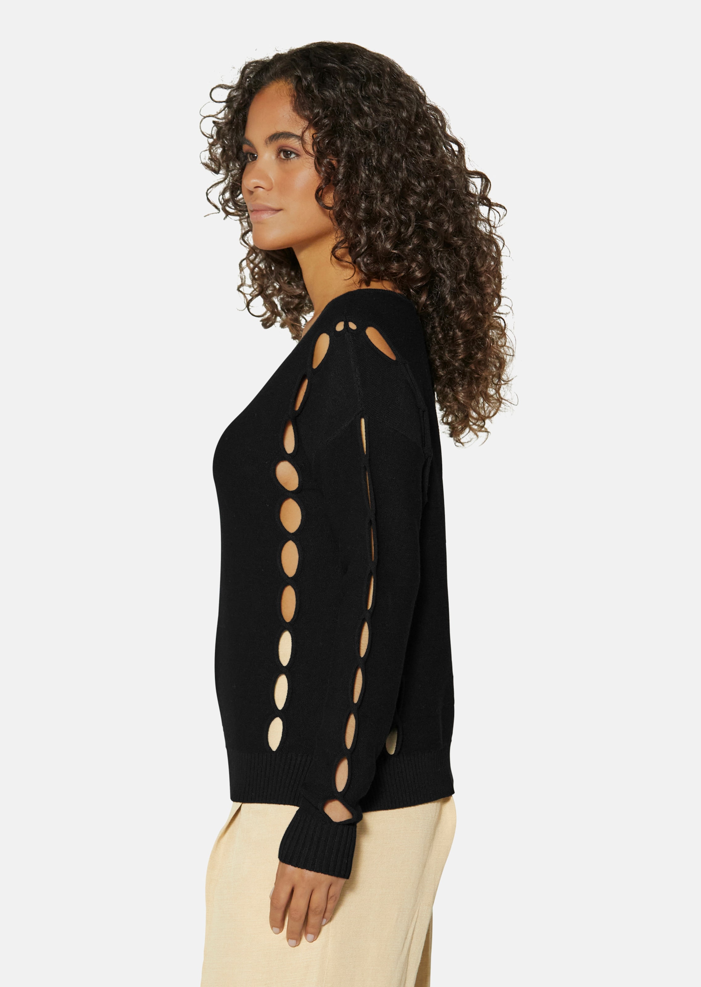 Knitted jumper with cut-outs and V-neckline in black | MADELEINE Fashion