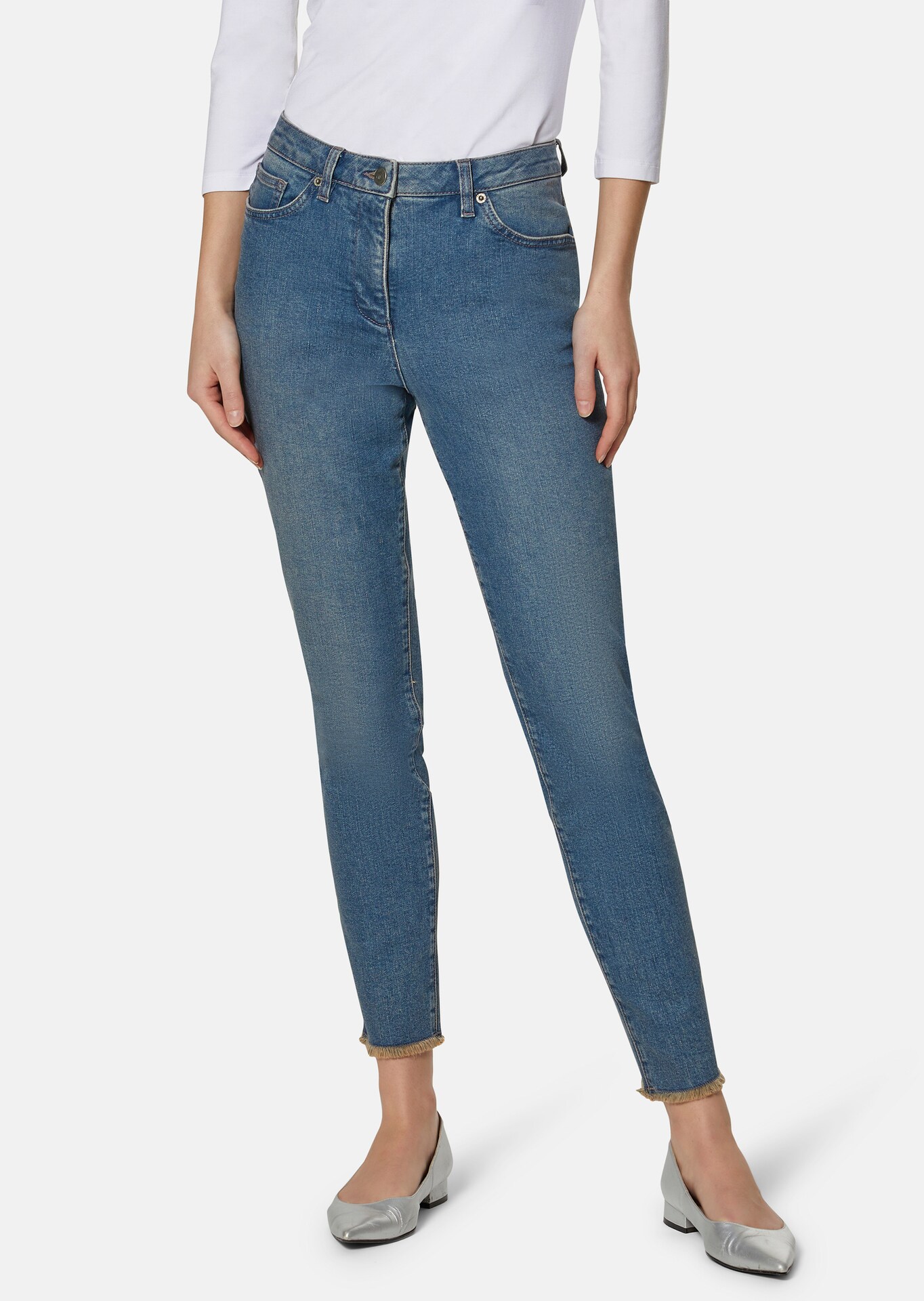 Jeans with fine fringing at the bottom of the legs in bleached ...