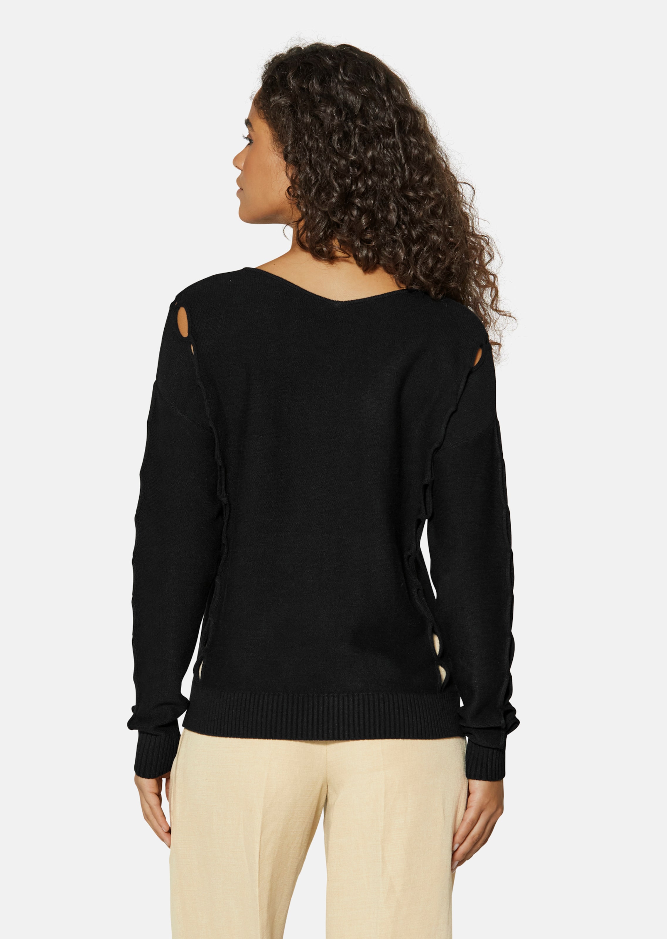 Knitted jumper with cut-outs and V-neckline in black | MADELEINE Fashion
